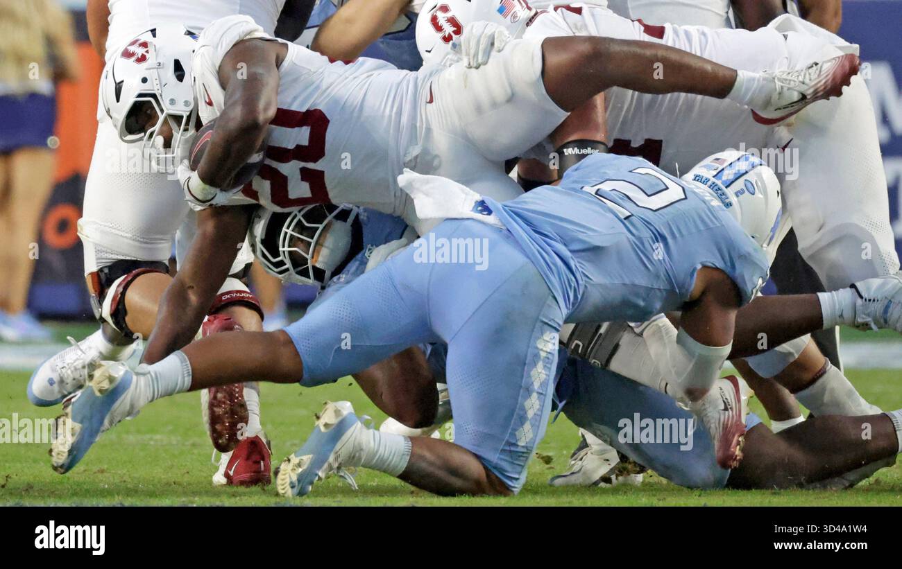 Stanford running back Micah Ford (20) gets upended by North Carolina ...