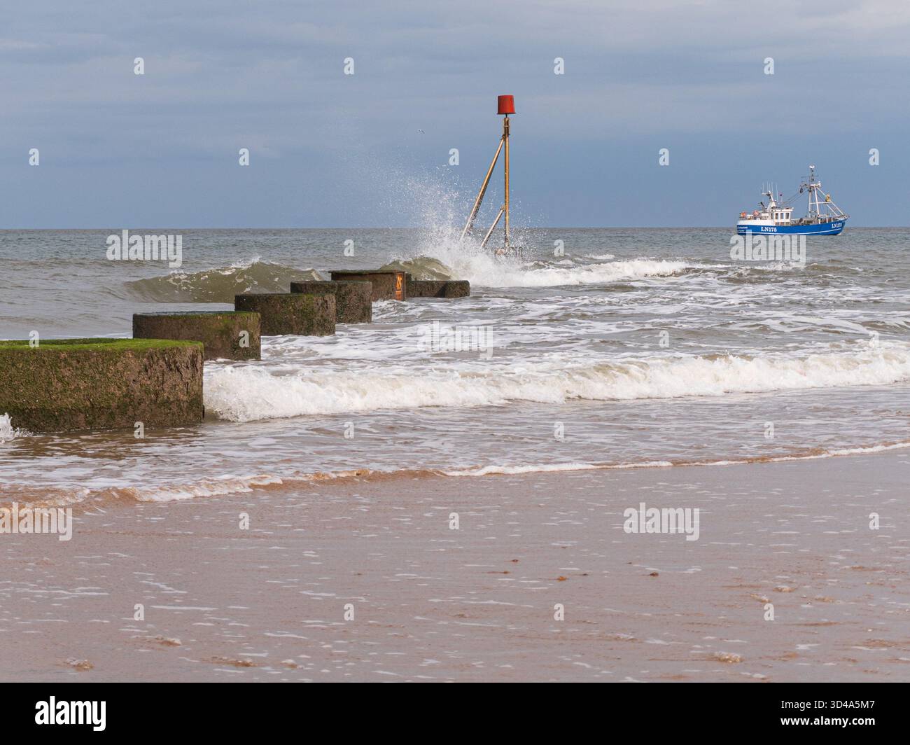 Wavebound: Groyne, Marker, and Fishing Vessel off Mablethorpe Stock ...