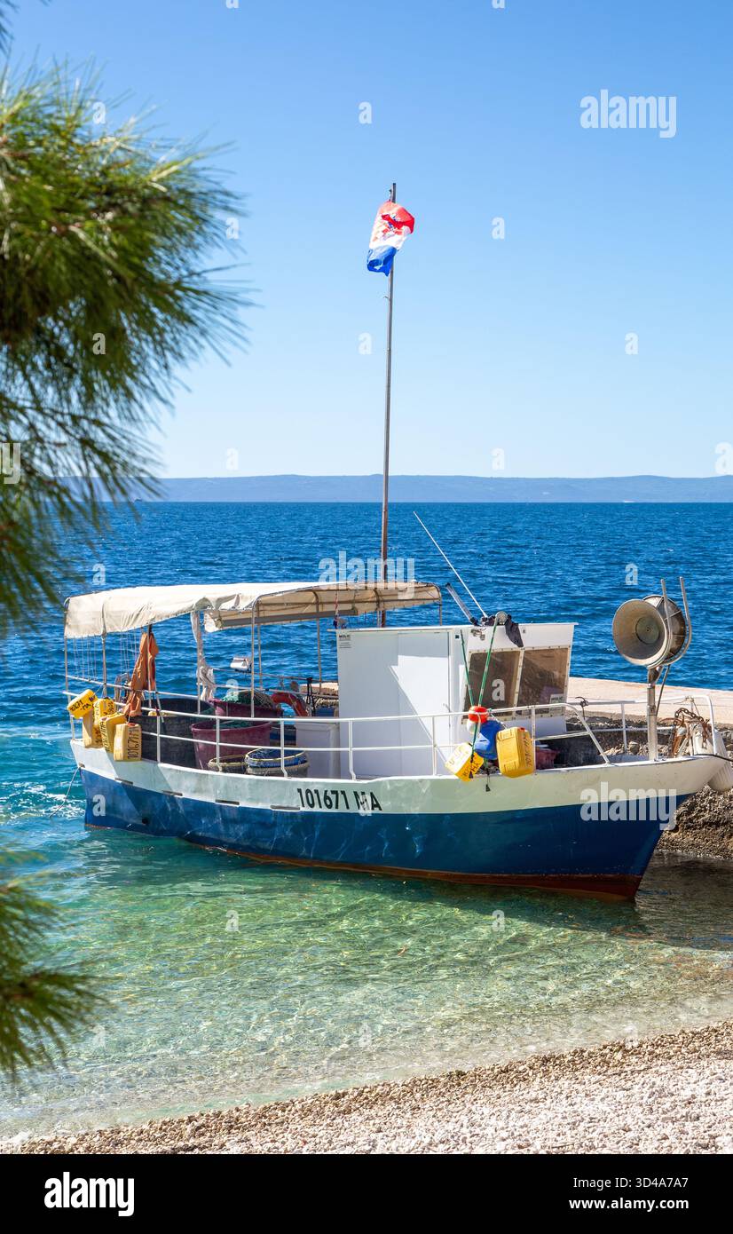 Traditional fishing boat anchored in the sea at the Croatian seaside ...