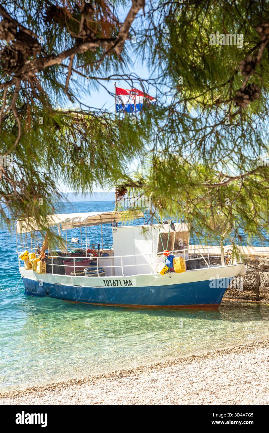 Traditional fishing boat anchored in the sea at the Croatian seaside ...
