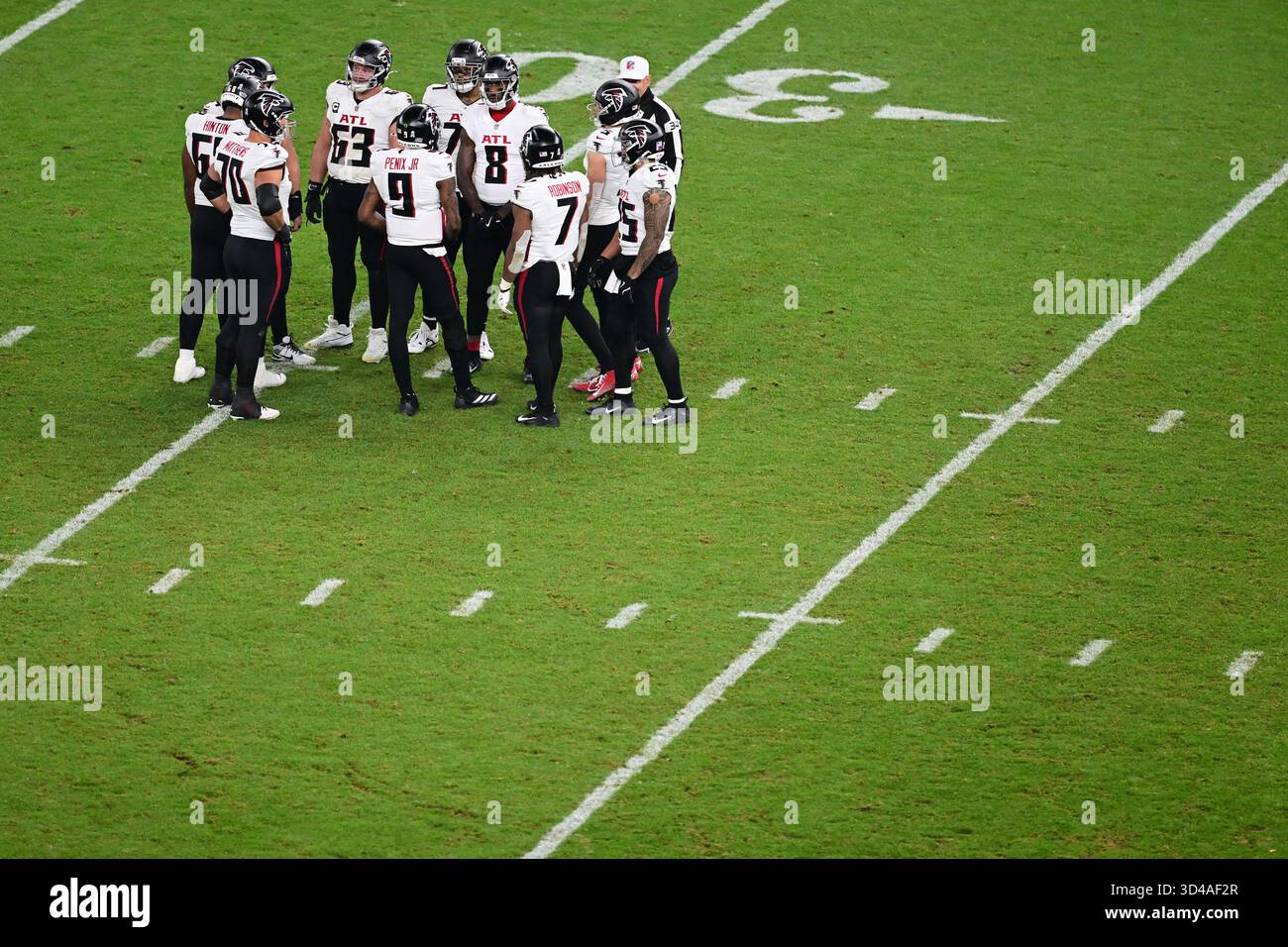 The Atlanta Falcons huddle up during an NFL football game against the ...