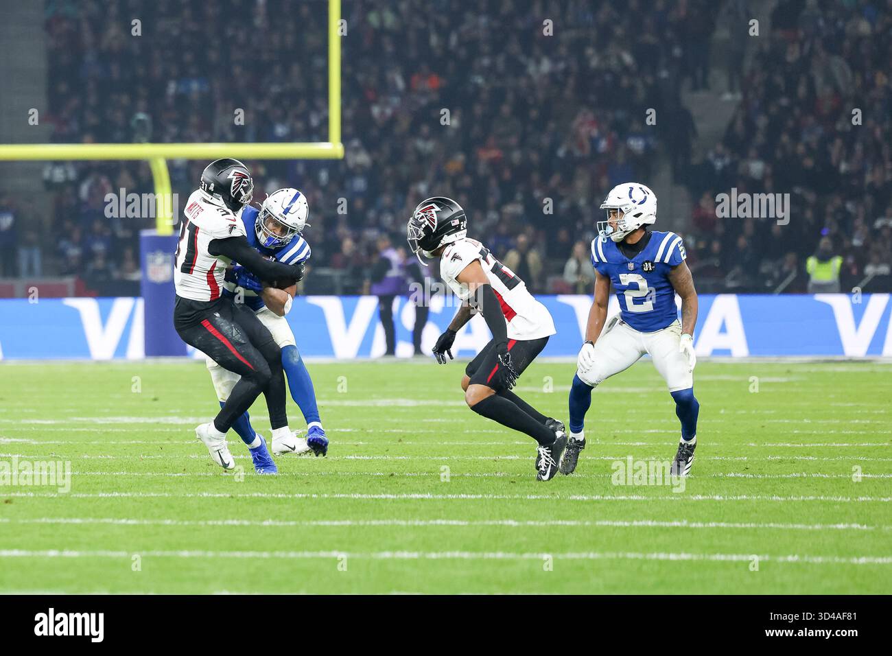 Jonathan Taylor (Indianapolis Colts, #28) with ball with Xavier Watts ...