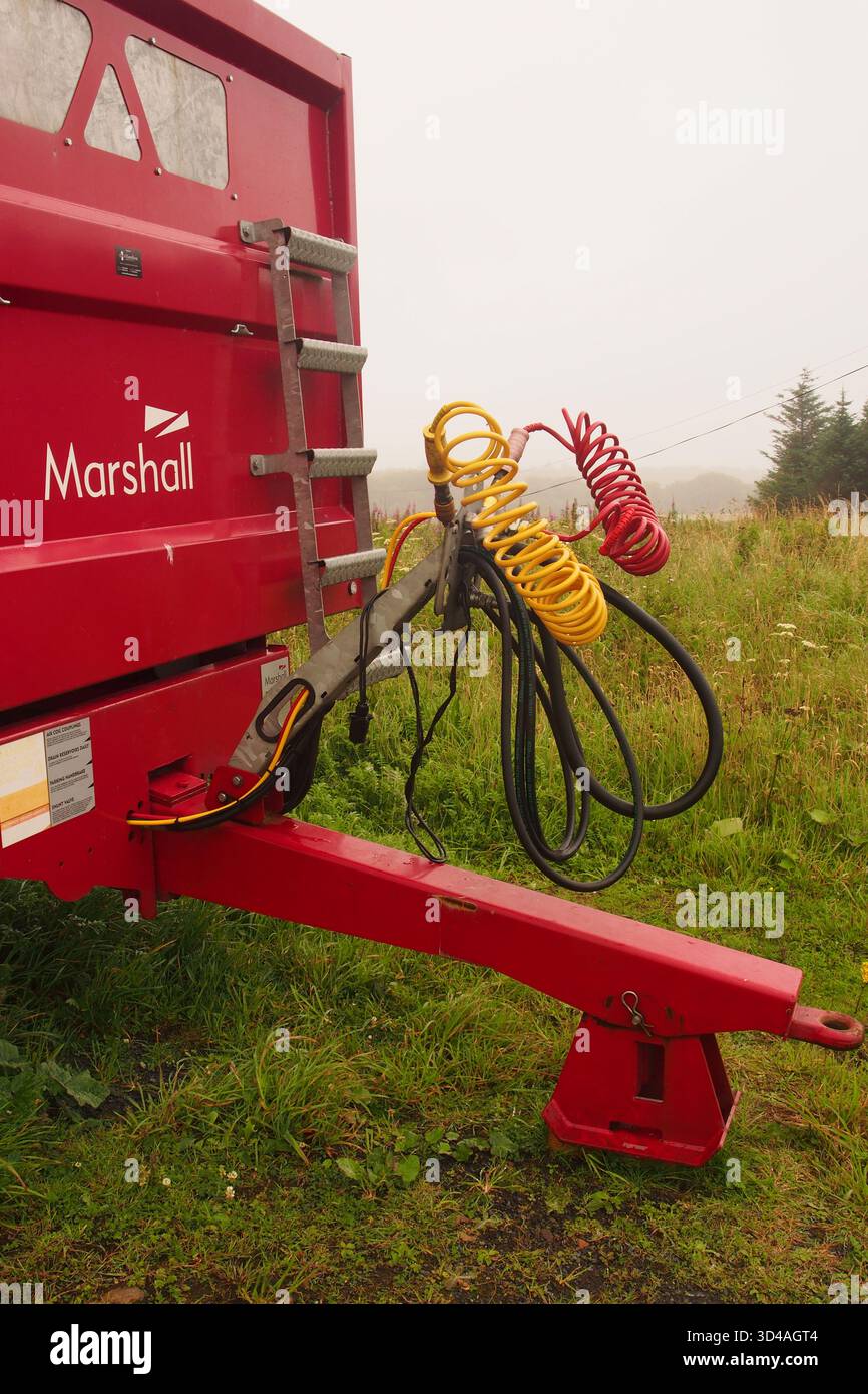 A huge, red, heavy duty, Marshall, silage and grain trailer, showing ...