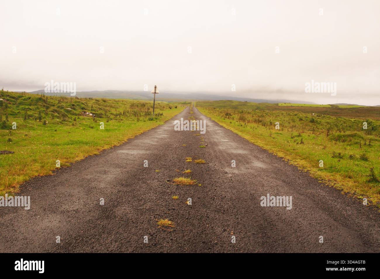 A straight country lane on Islay, Inner Hebrides, Scotland UK, showing ...
