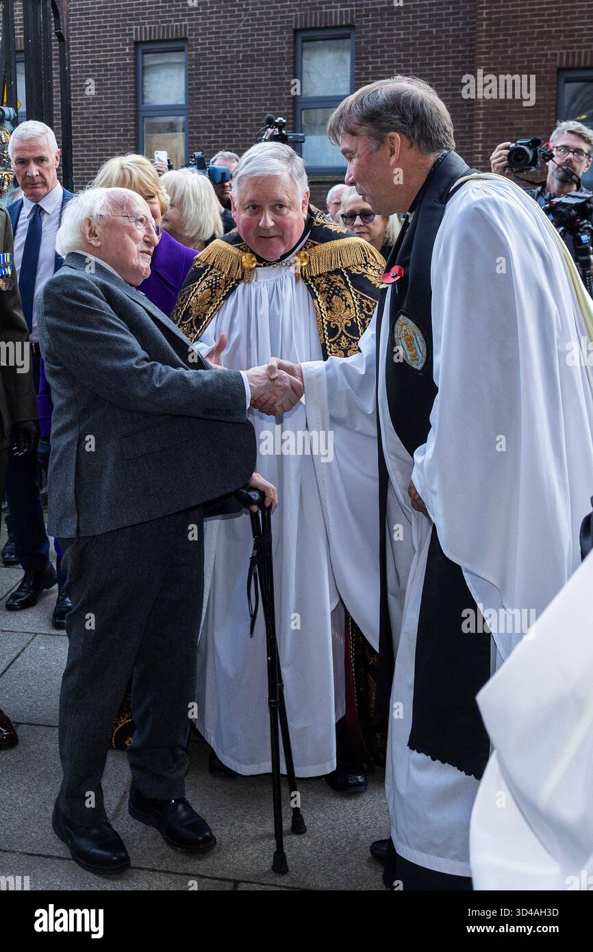 President Michael D. Higgins (left) is greeted by the precentor, Peter ...