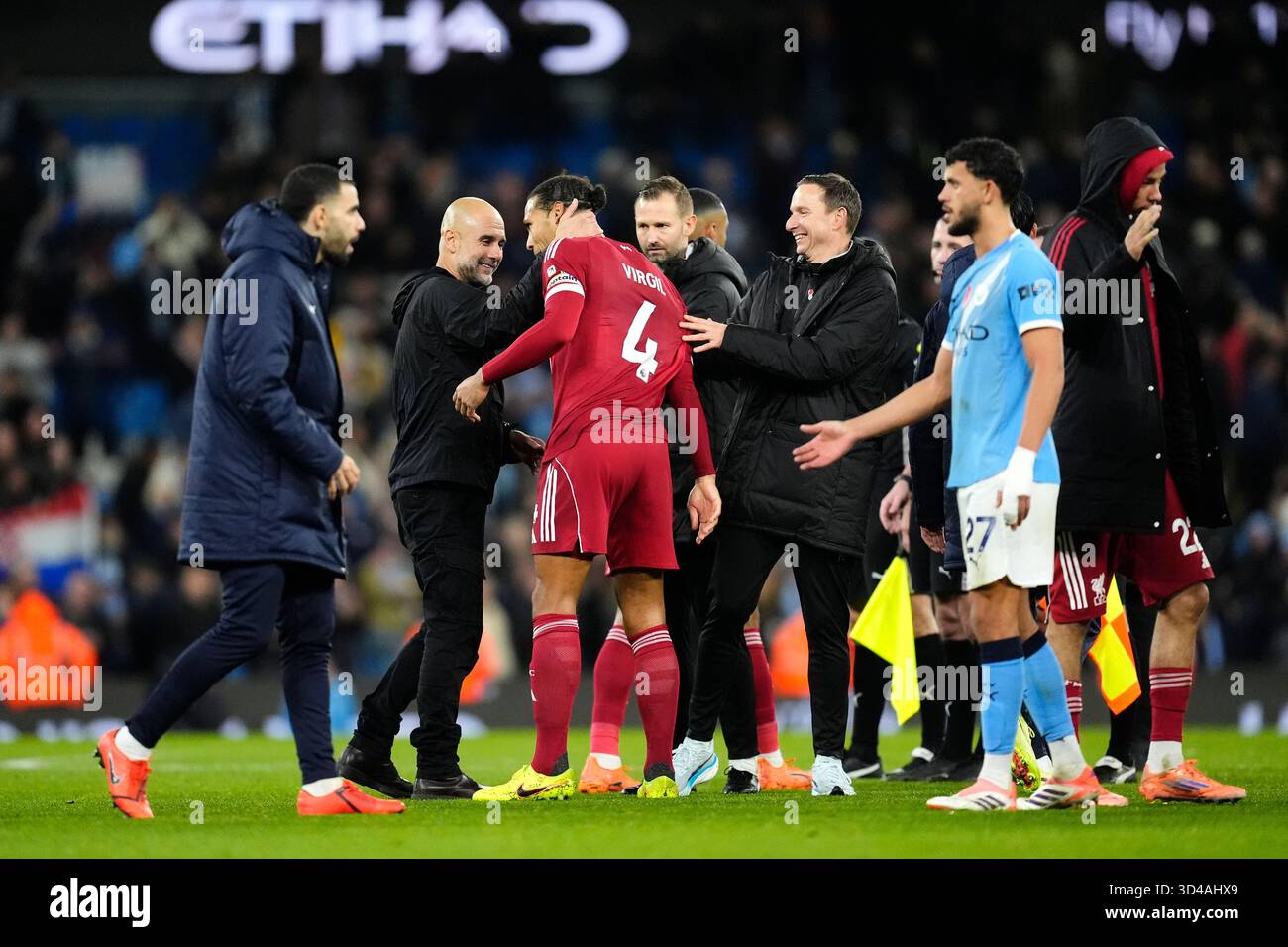 Manchester City manager Pep Guardiola (second left) and first team ...