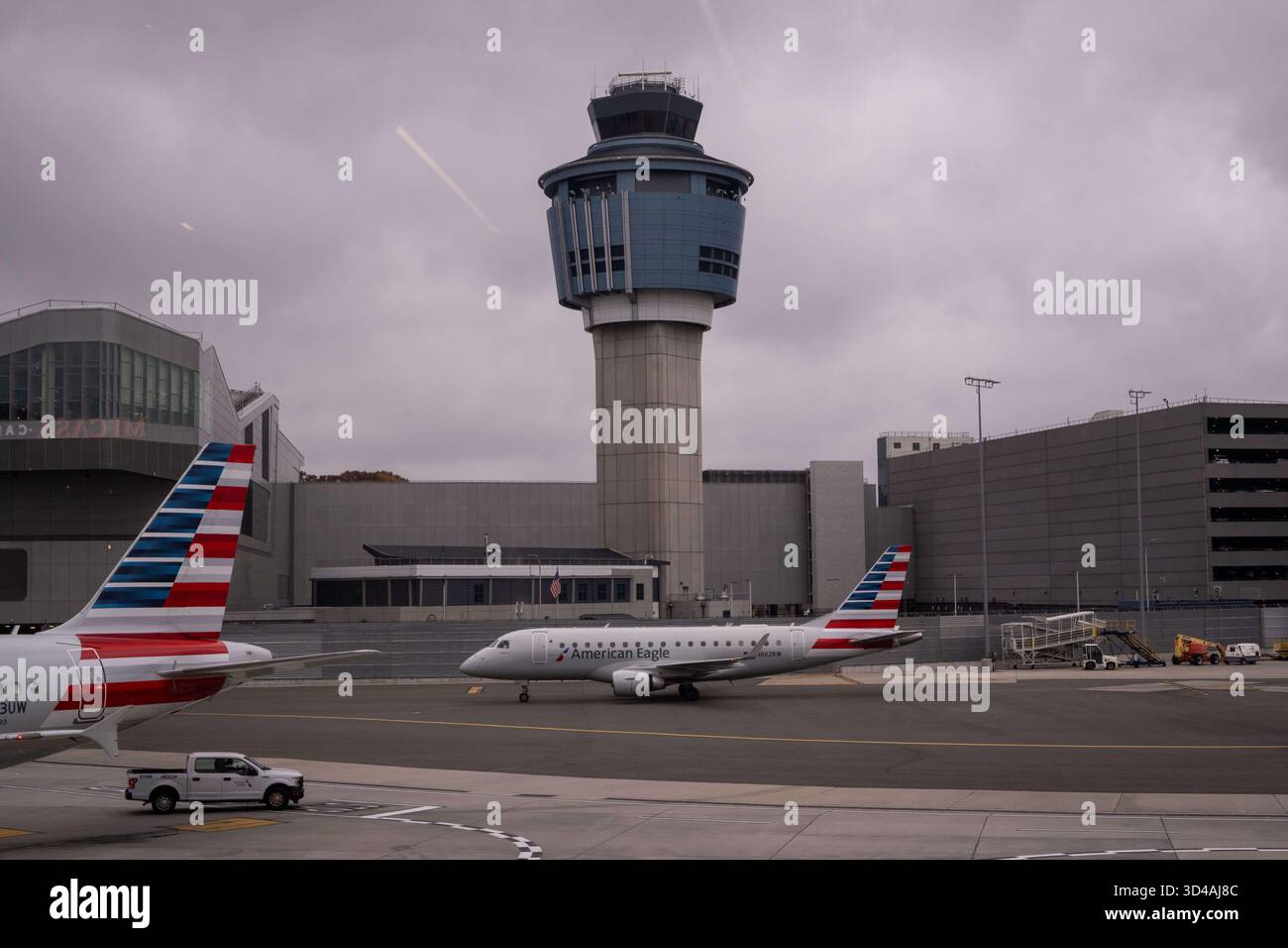 An American Eagle plane moves past the FAA Air Traffic Control tower at ...