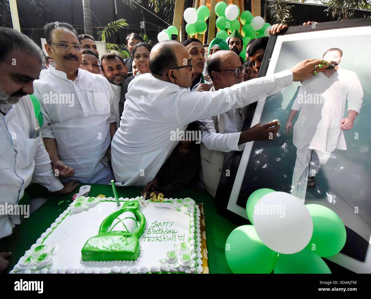 PATNA, INDIA - NOVEMBER 9: RJD leaders cutting the cake to celebrating ...