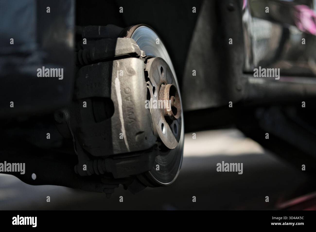 Mechanic performing tire change, wheel alignment and balancing at an ...