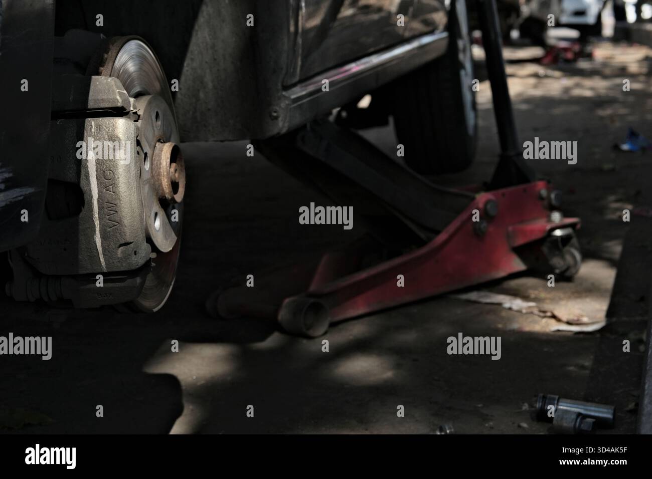 Mechanic performing tire change, wheel alignment and balancing at an ...