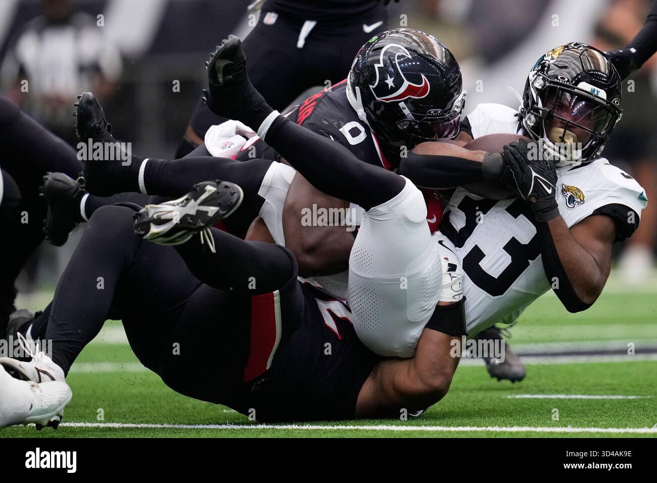 Jacksonville Jaguars running back Bhayshul Tuten (33) is tackled by ...