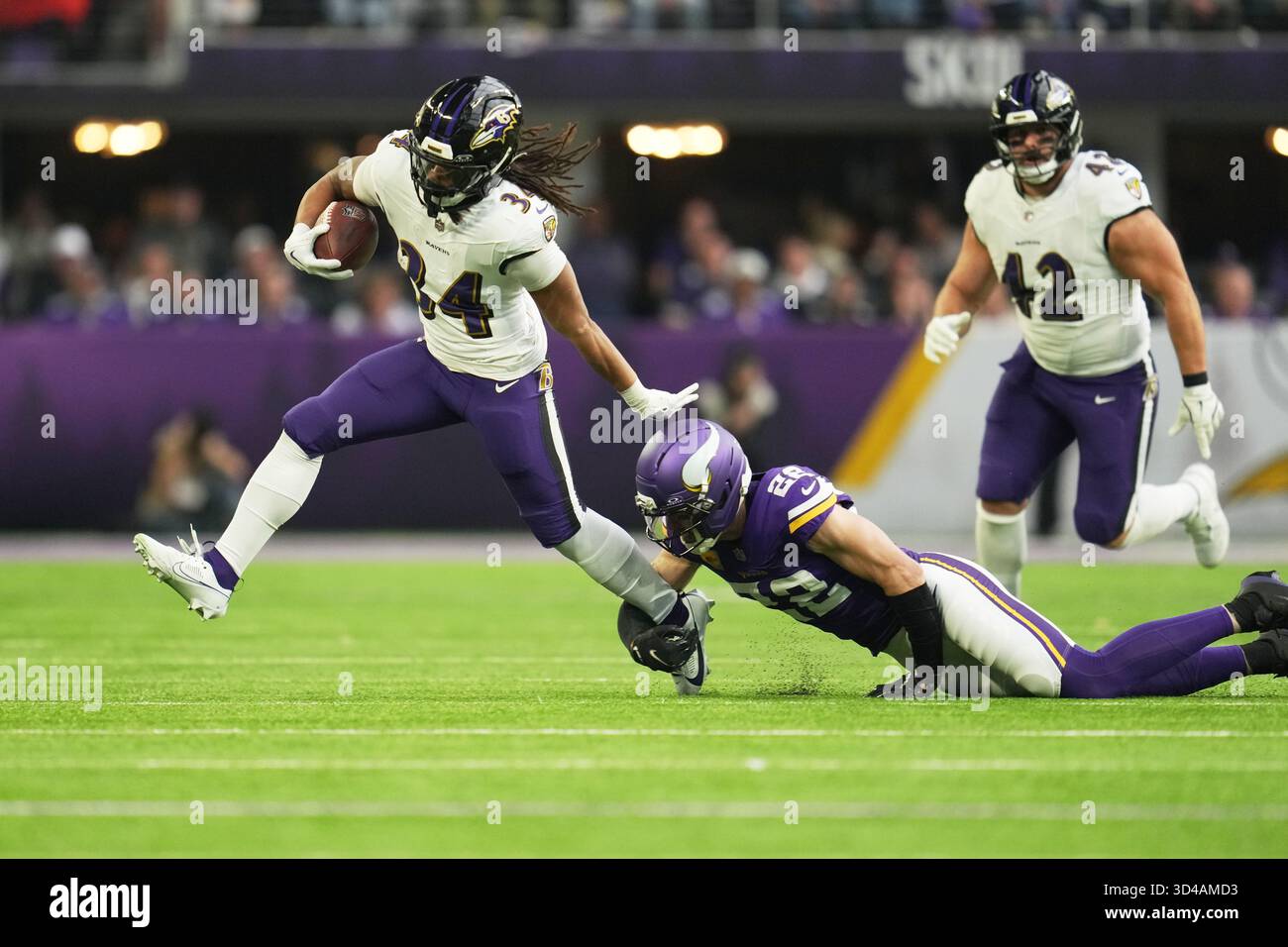 Baltimore Ravens running back Keaton Mitchell (34) is tackled by ...