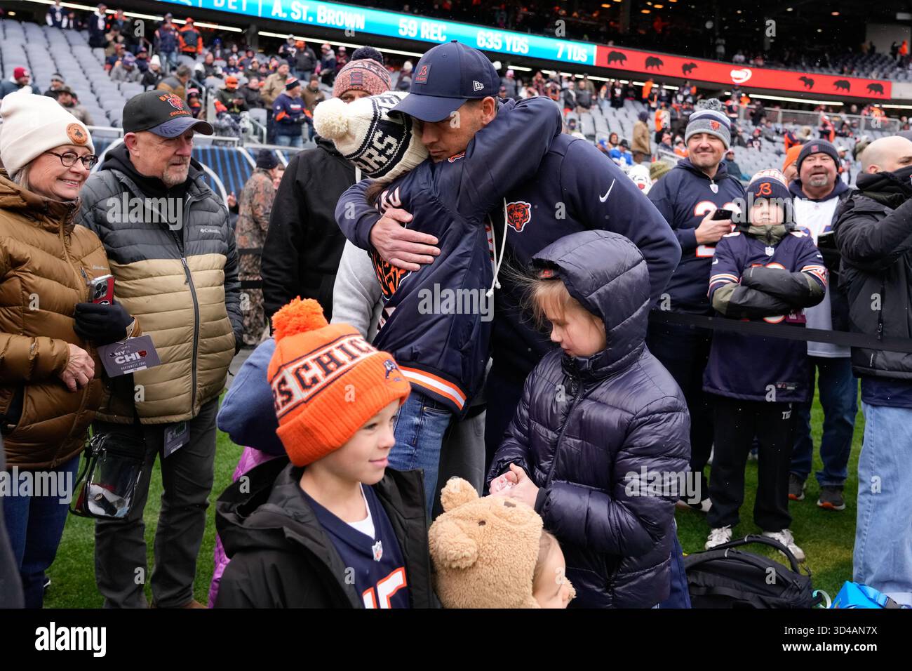 Chicago Bears head coach Ben Johnson, center top right, hugs his wife ...