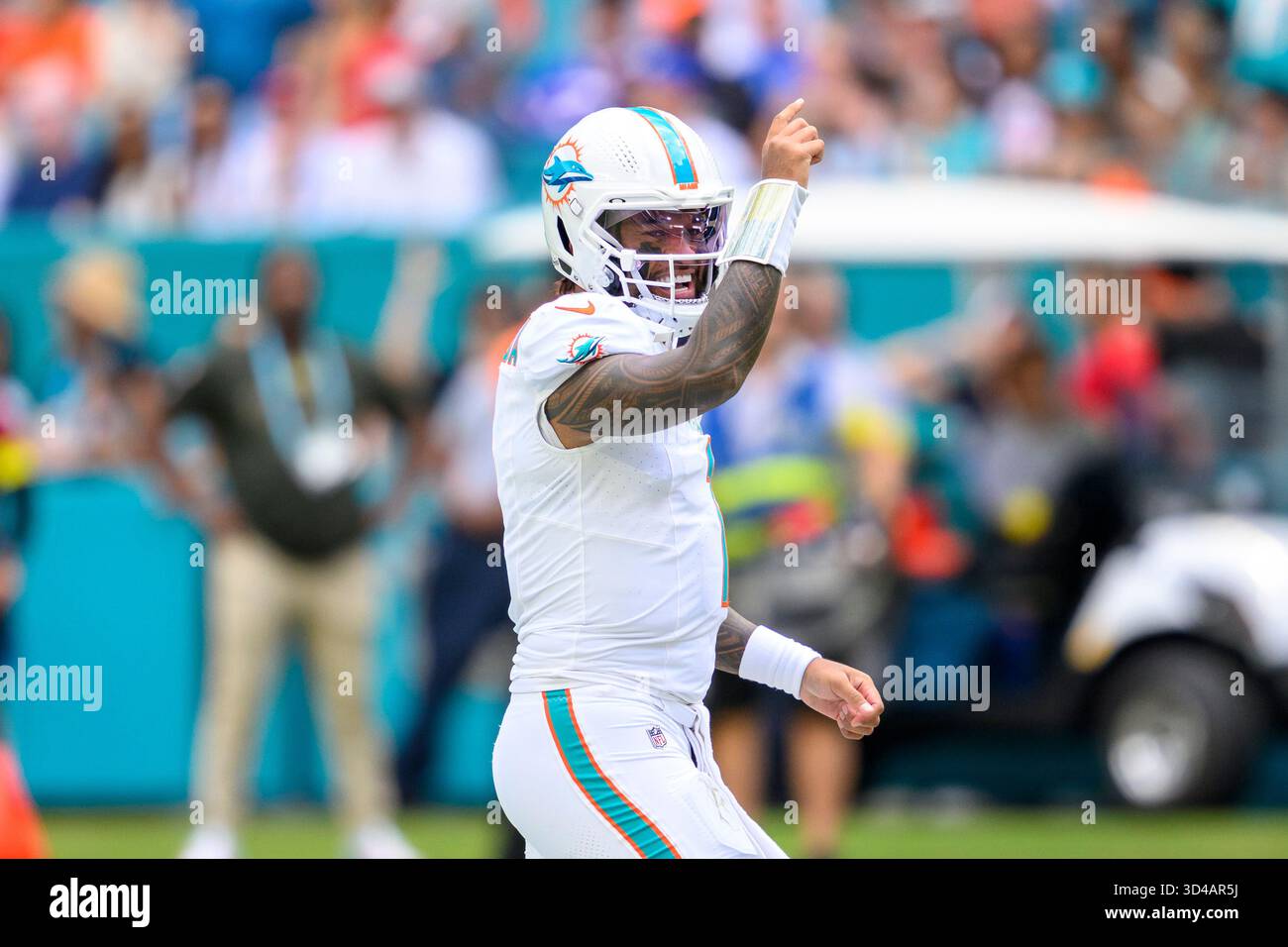 Miami Dolphins quarterback Tua Tagovailoa (1) raises his arm and smiles ...