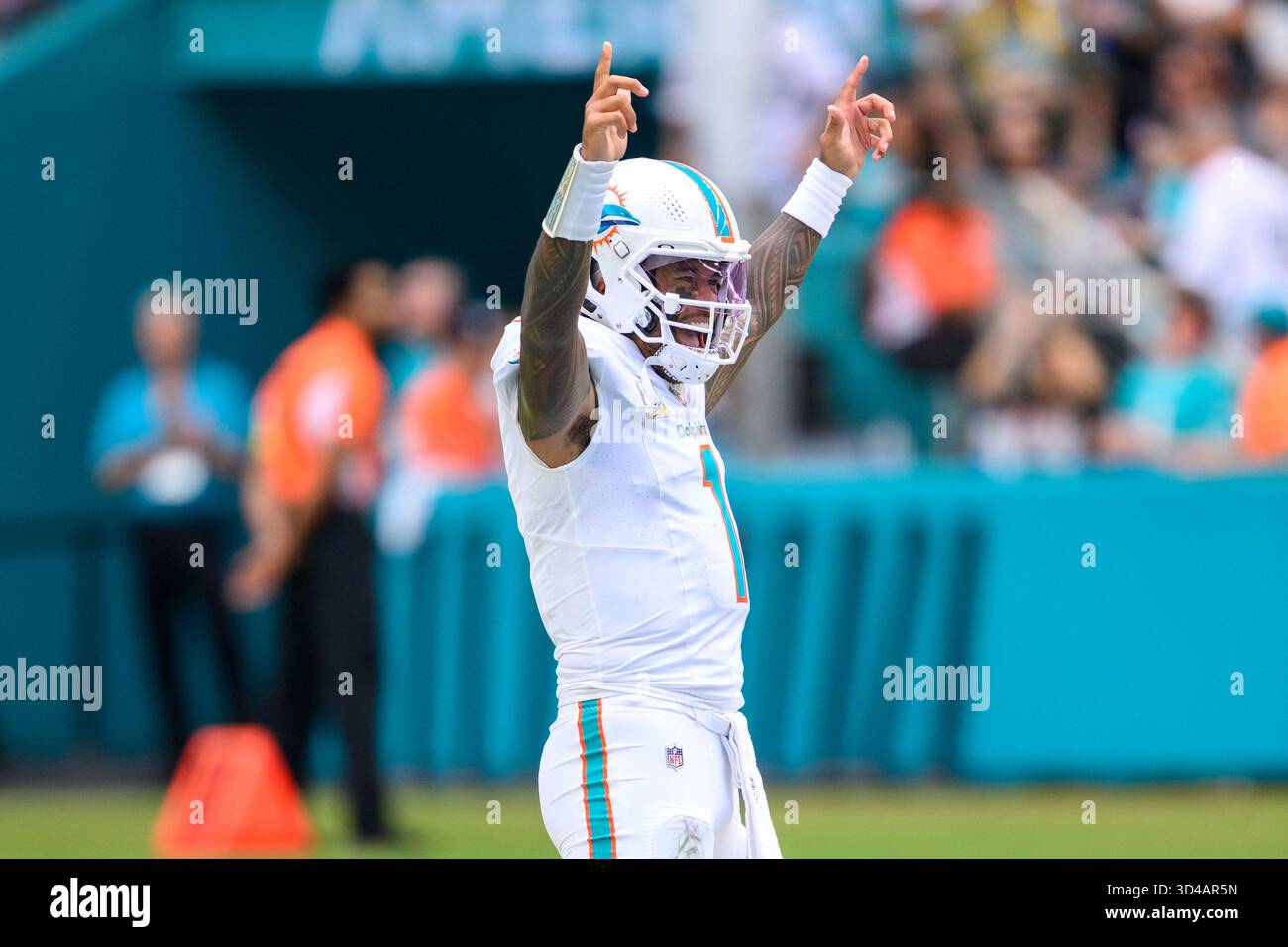 Miami Dolphins quarterback Tua Tagovailoa (1) raises his arms and yells ...