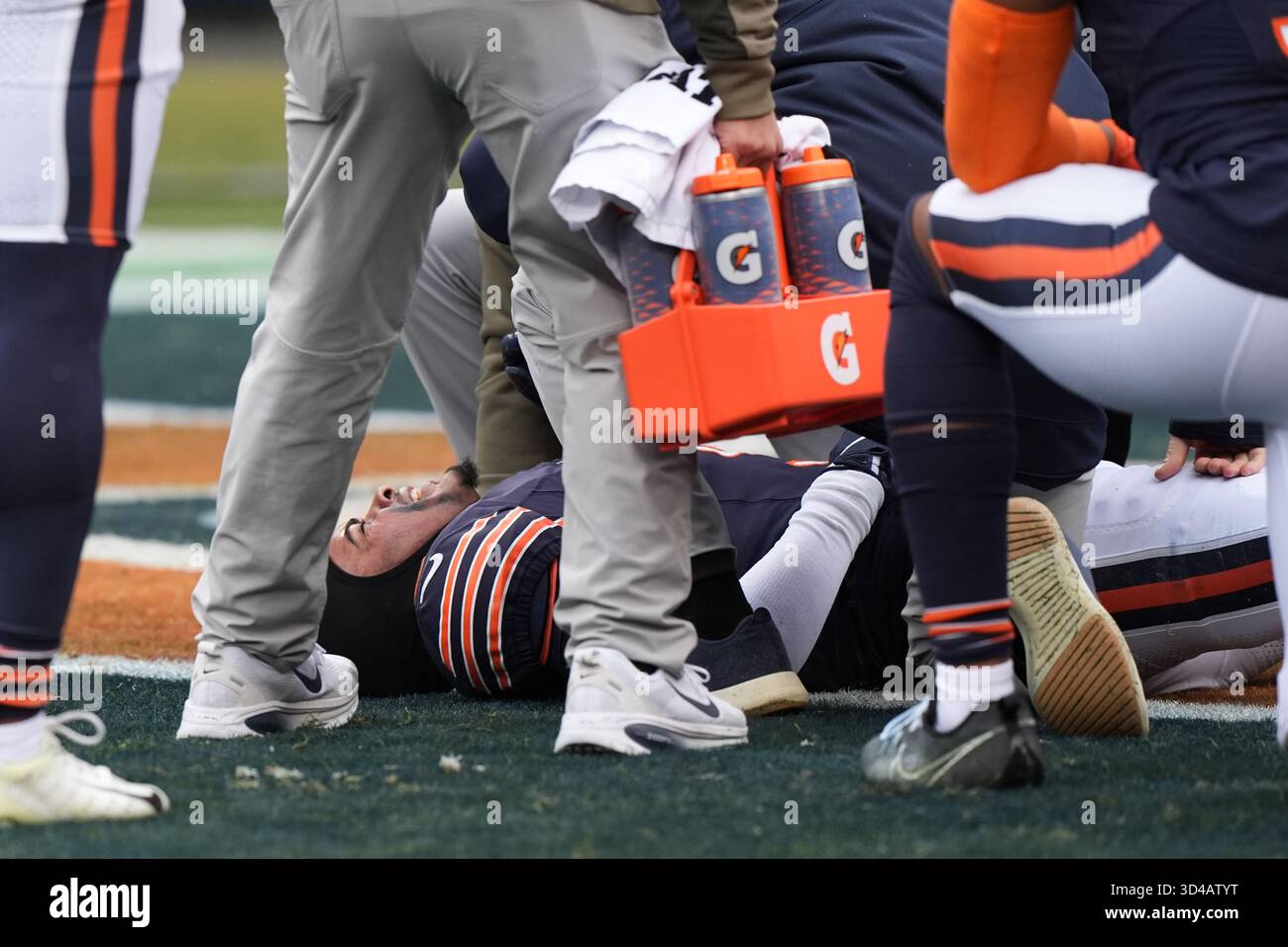 Chicago Bears safety Jaquan Brisker lies on the field after a play ...