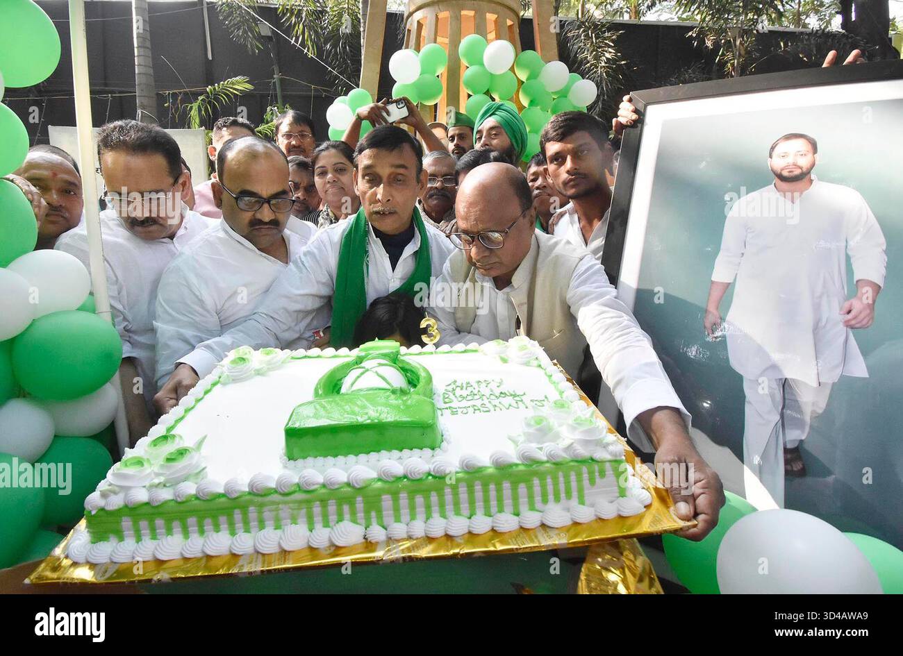 PATNA, INDIA - NOVEMBER 9: RJD leaders cutting the cake to celebrating ...