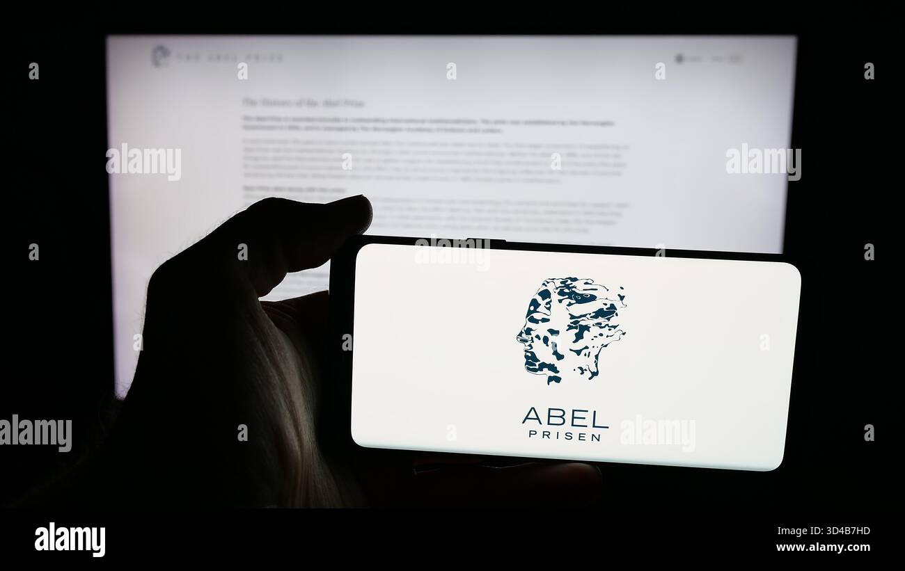 Stuttgart, Germany - 10-31-2025: Person holding mobile phone with logo ...