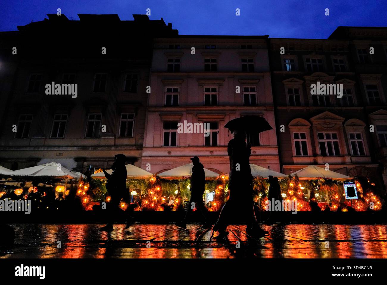 People walk through the main market square, Sunday, Nov. 9, 2025, in ...