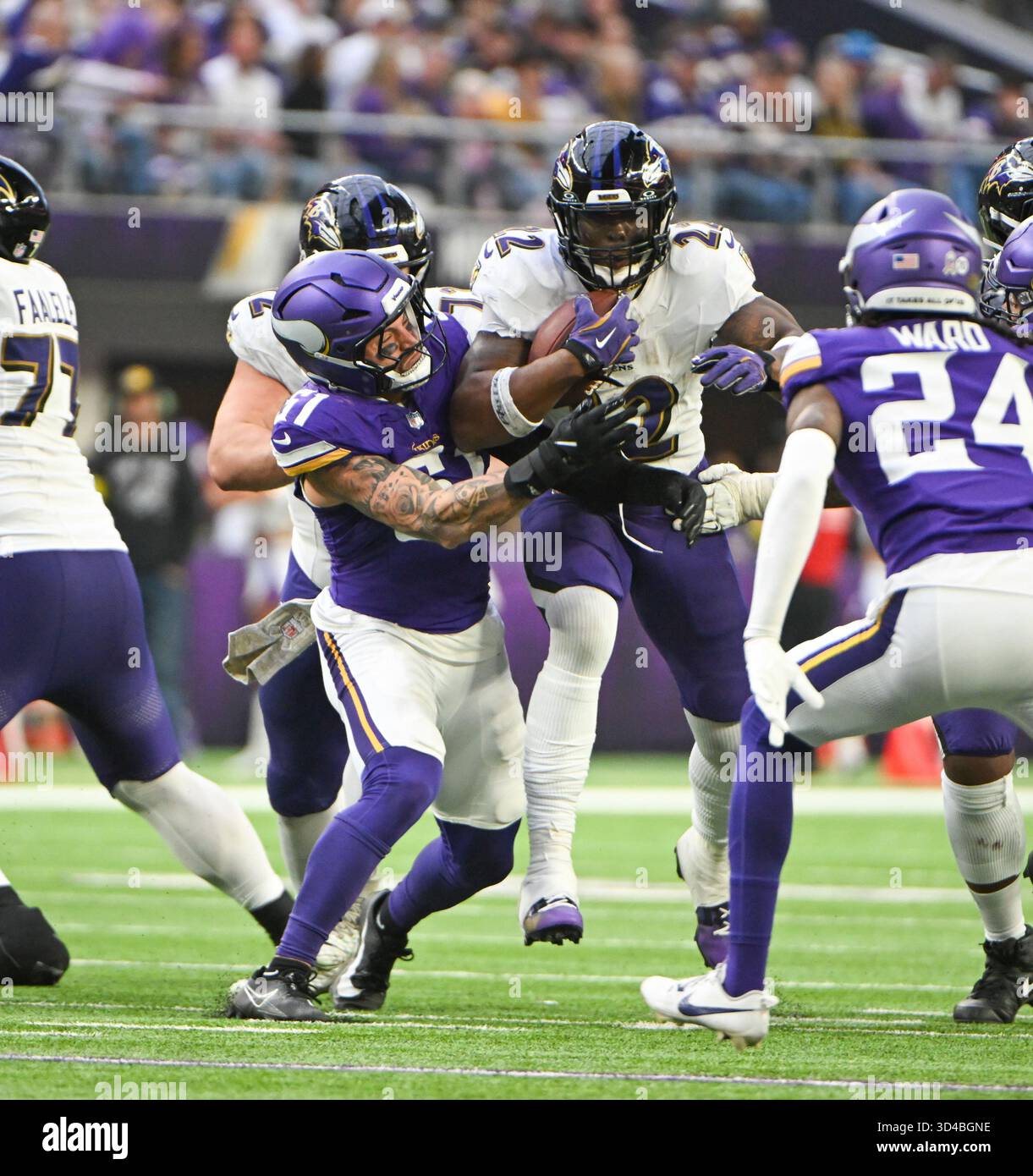 Baltimore Ravens running back Derrick Henry (R) is tackled by Minnesota ...