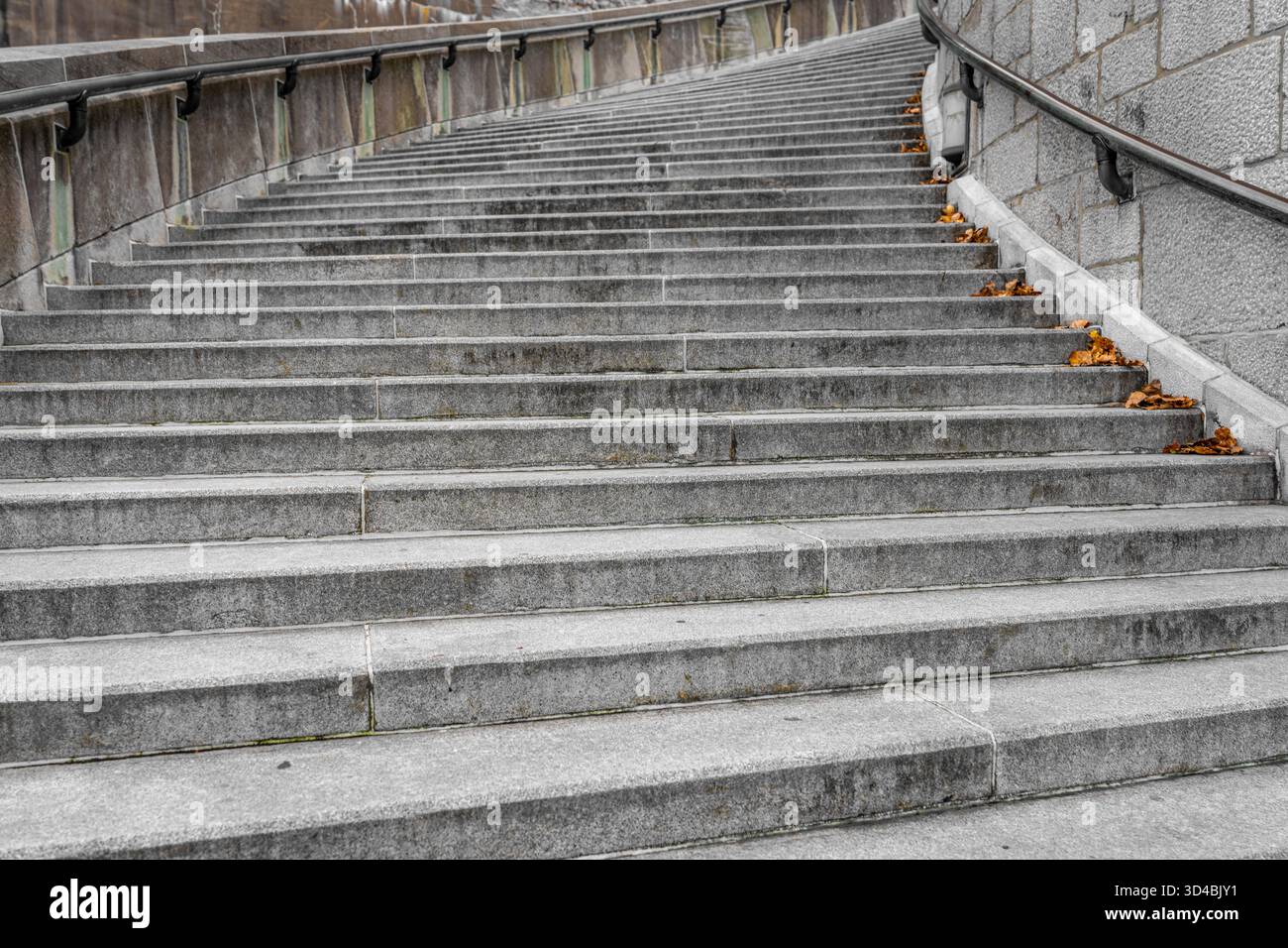 Color photo looking up an old winding concrete stairs on a cold day ...