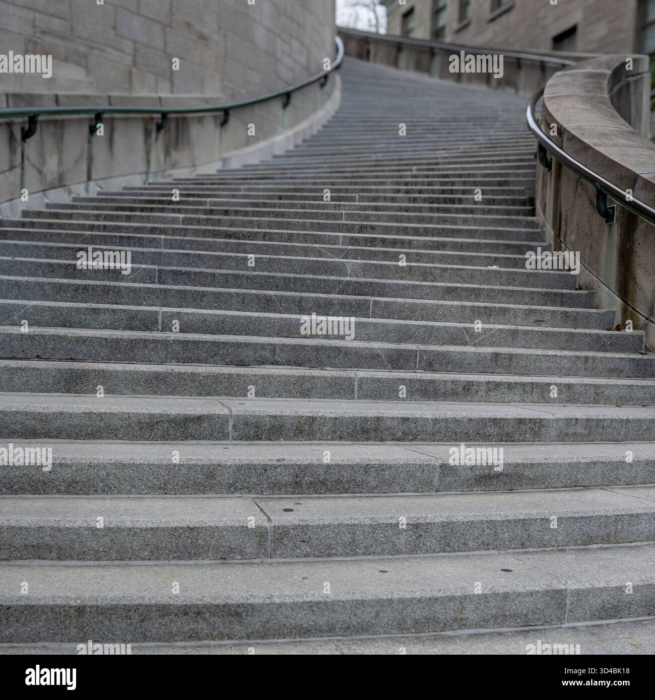 Color photo looking up an old winding concrete stairs on a cold day ...