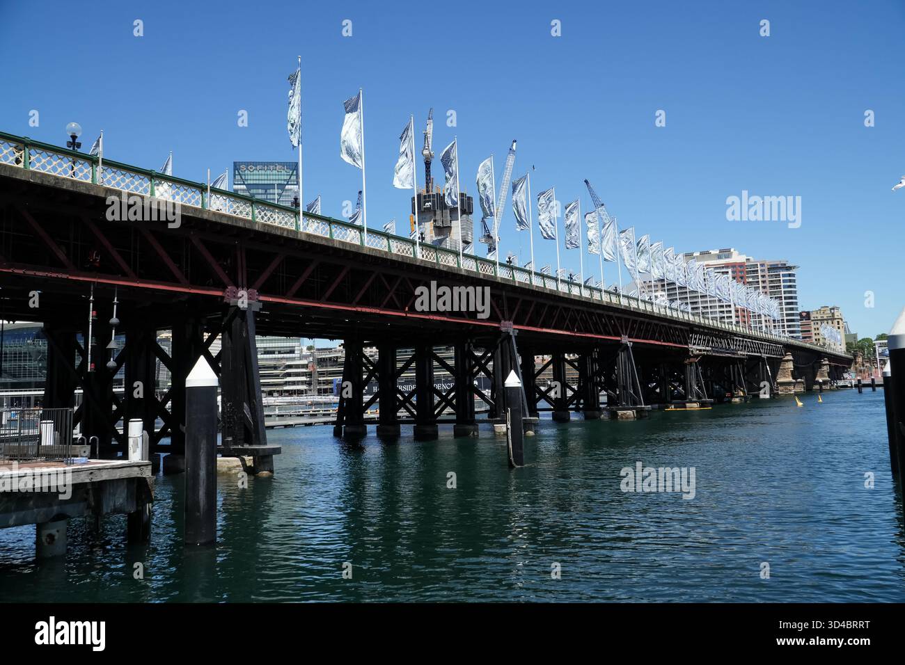 Pyrmont Bridge, a historic swing bridge, extends across Darling Harbour ...