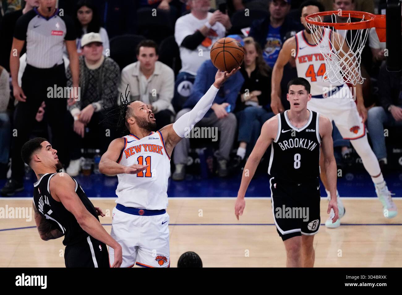 New York Knicks' Jalen Brunson (11) drives past Brooklyn Nets' Michael ...
