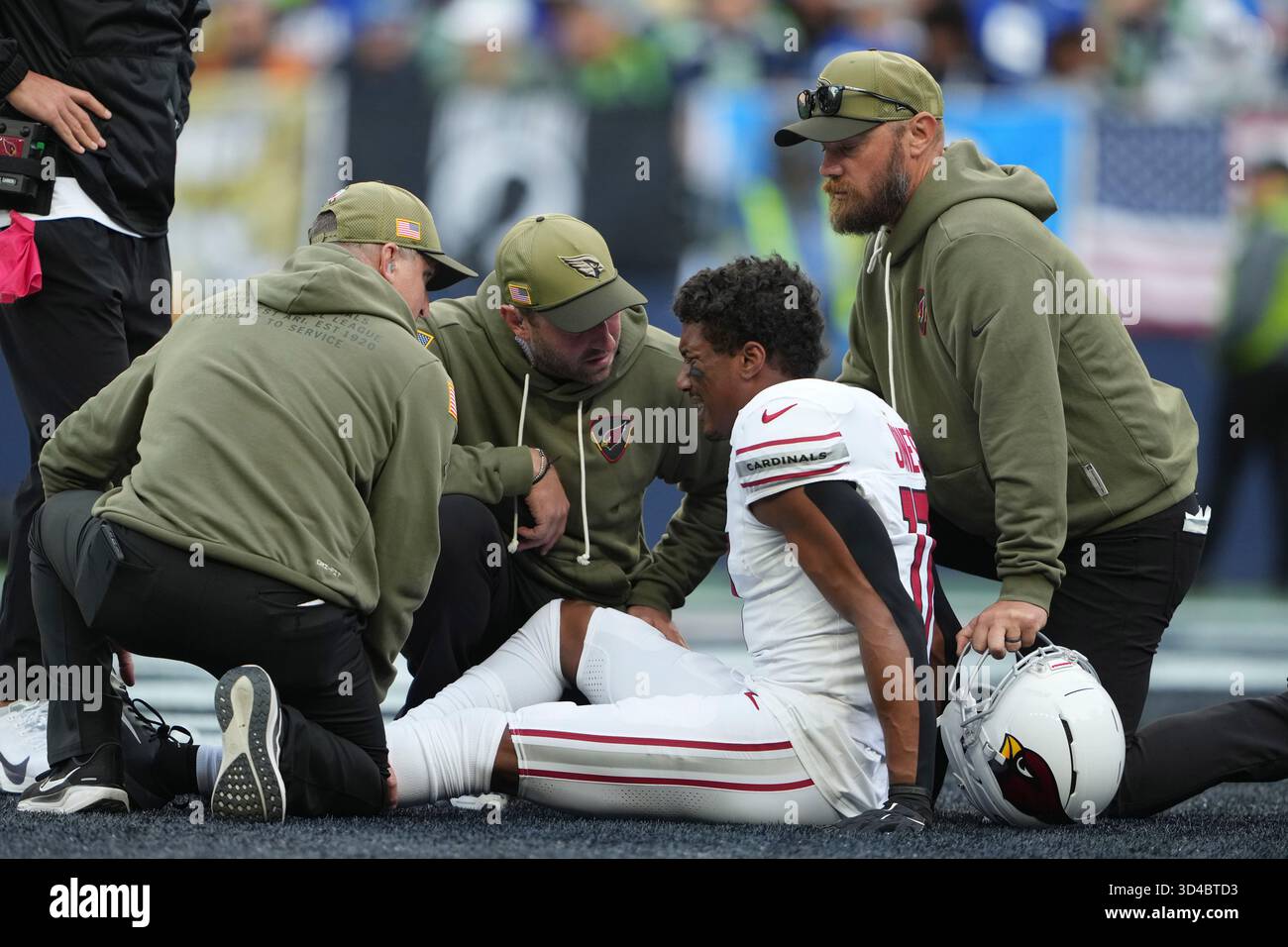 An injured Arizona Cardinals wide receiver Zay Jones is attended to by ...
