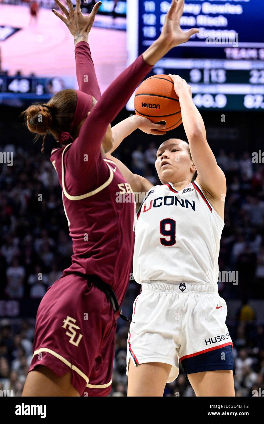 UConn guard Kayleigh Heckel (9) looks to shoot over Florida State guard ...