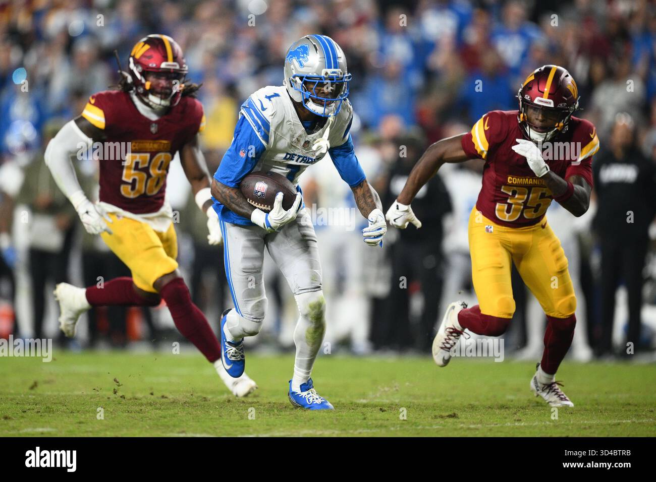 Detroit Lions wide receiver Jameson Williams (1) runs with the ball ...