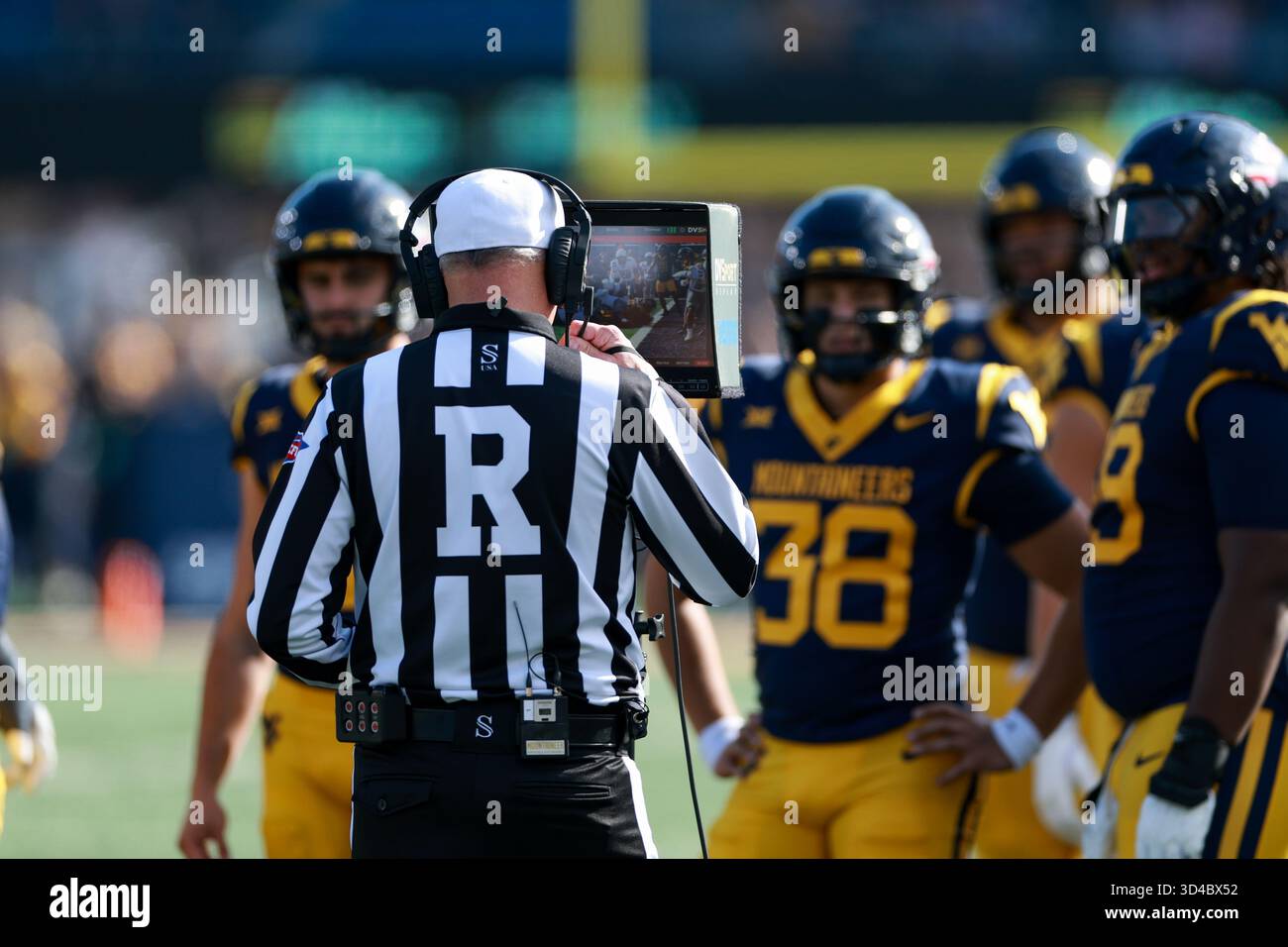 November 8, 2025: A referee reviews an instant replay as West Virginia ...