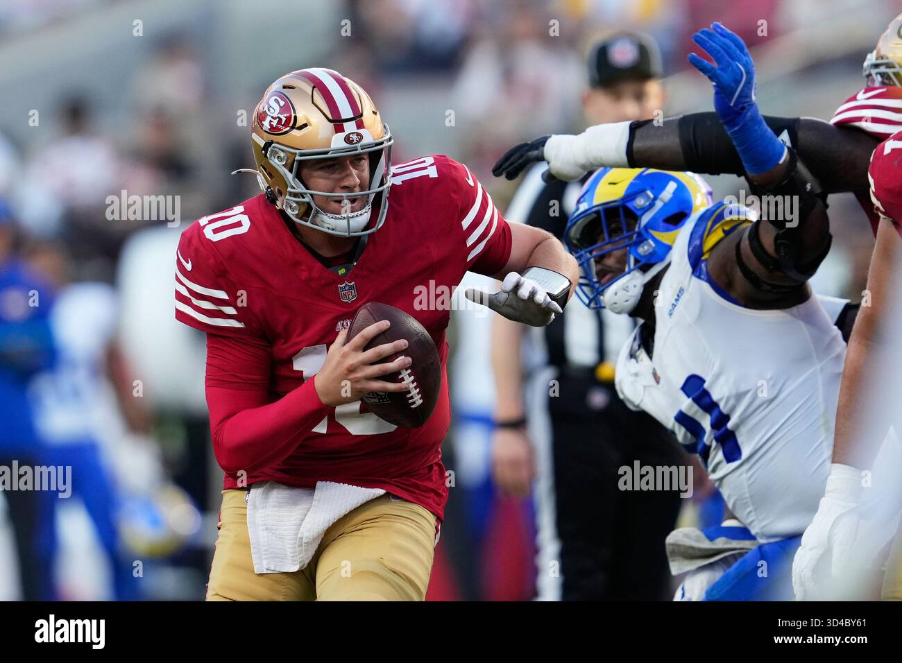 San Francisco 49ers quarterback Mac Jones (10) scrambles against the ...