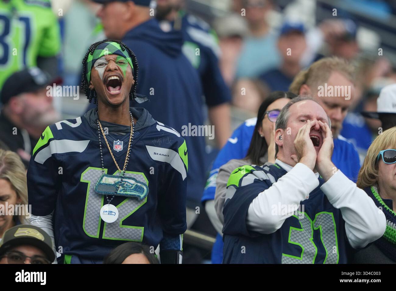 Seattle Seahawks fans shout as they watch the action on the field ...