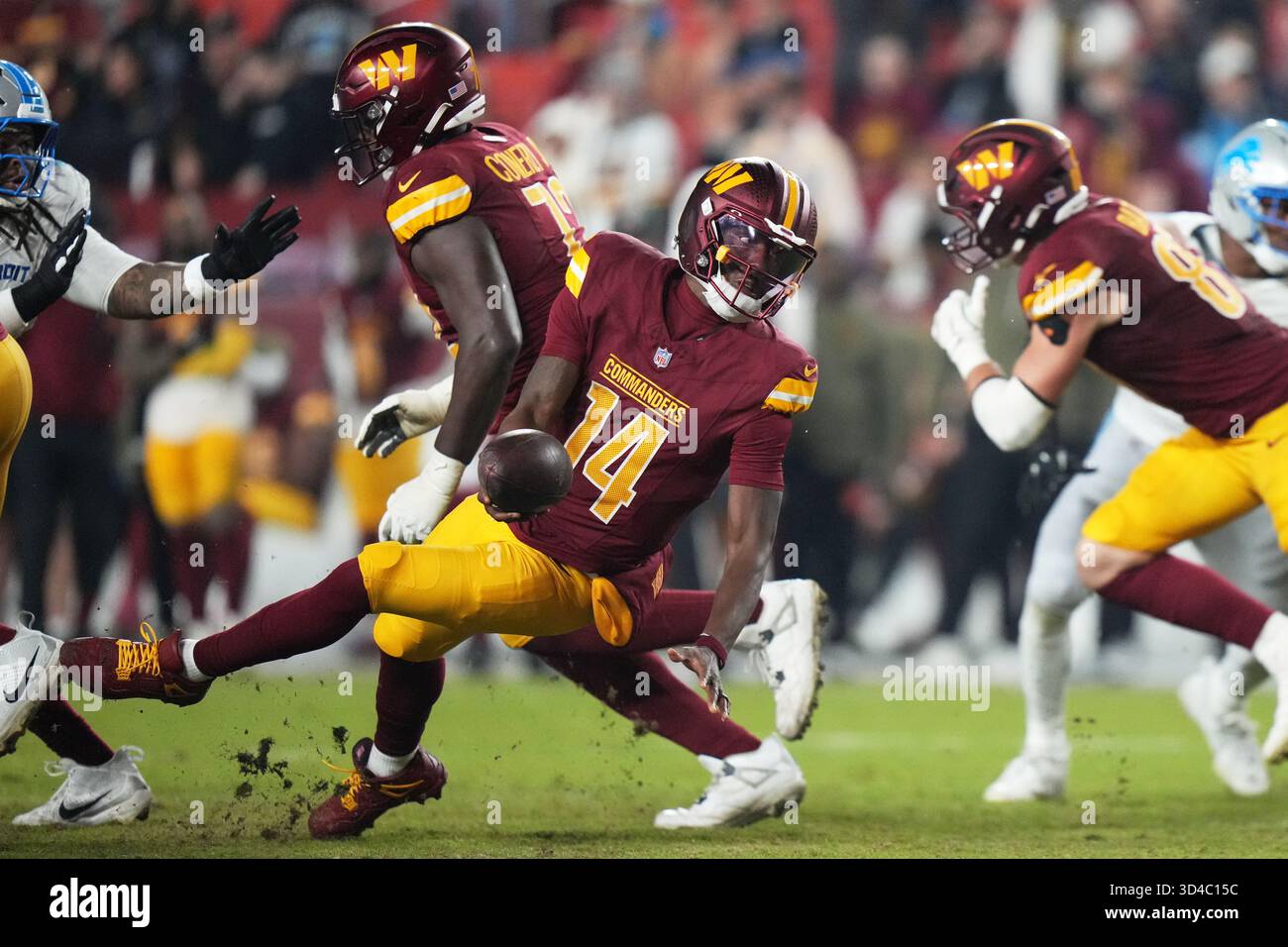 Washington Commanders quarterback Josh Johnson (14) falls during the ...