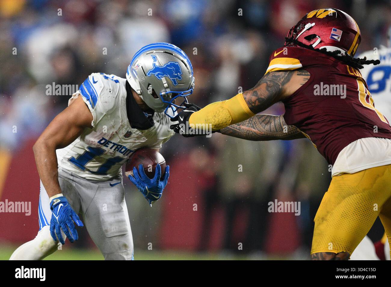 Washington Commanders linebacker Frankie Luvu (4) grabs Detroit Lions ...