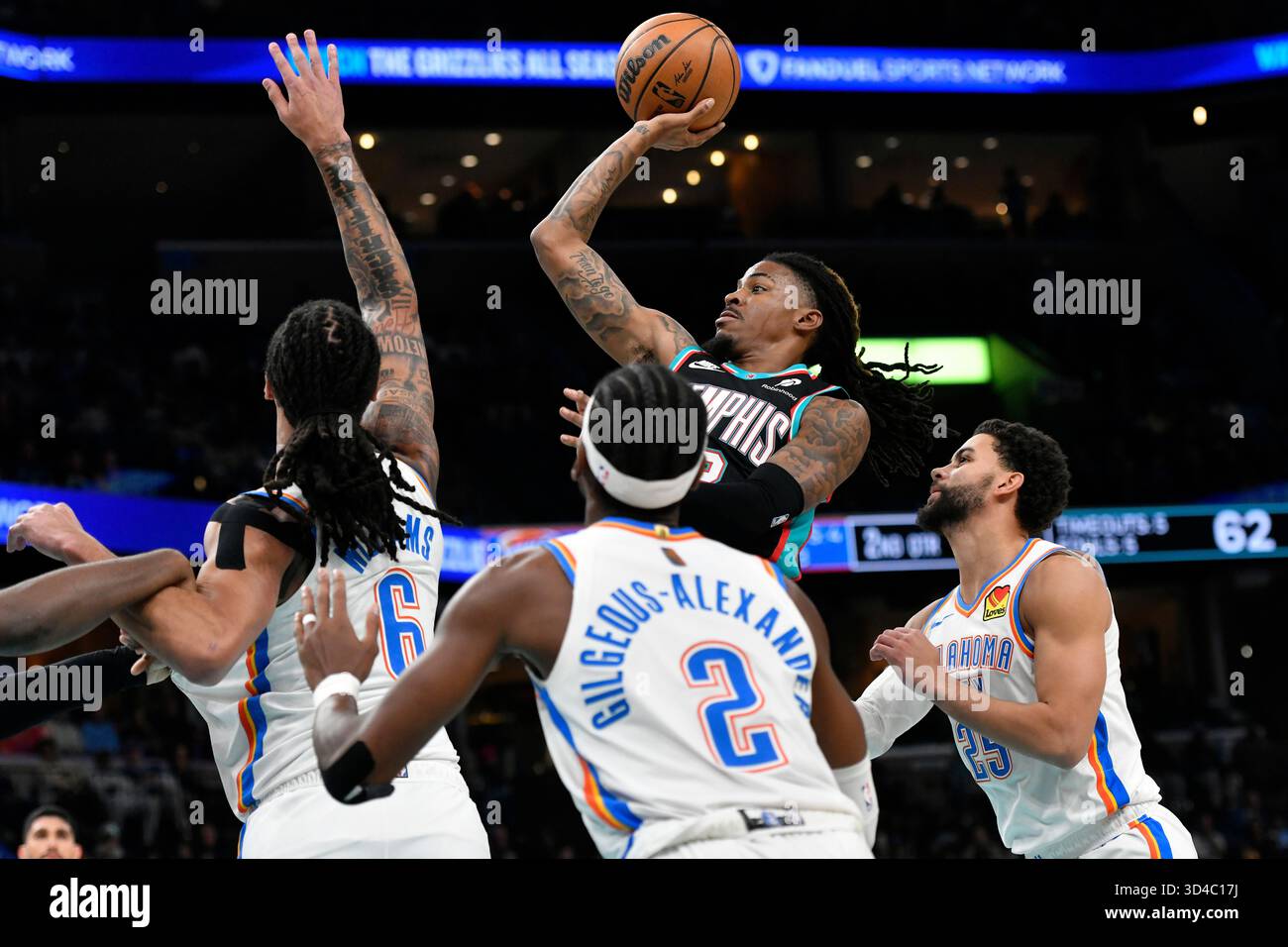 Memphis Grizzlies guard Ja Morant, top right, goes up to shoot over ...