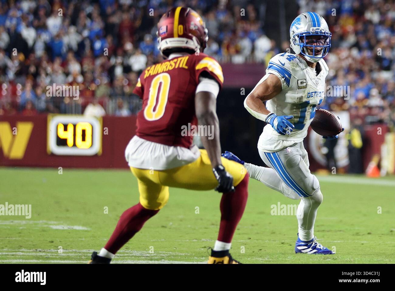 Detroit Lions wide receiver Amon-Ra St. Brown (14) runs with the ball during an NFL football ...