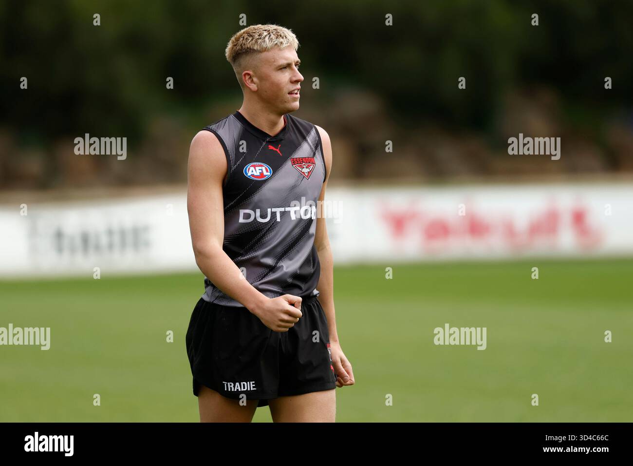 Nate Caddy (L) warming up during an Essendon Bombers AFL training ...