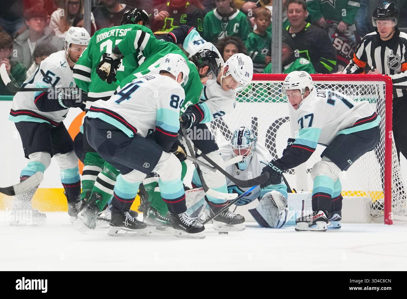 Seattle Kraken goaltender Matt Murray, center bottom, eyes the puck as ...