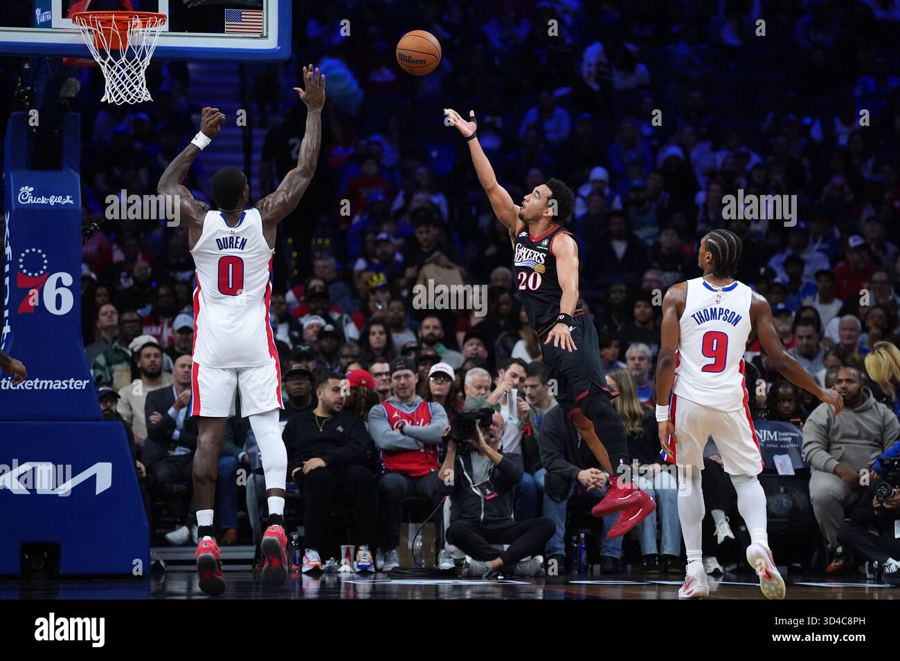 Philadelphia 76ers' Jared McCain (20) goes up for a shot between ...