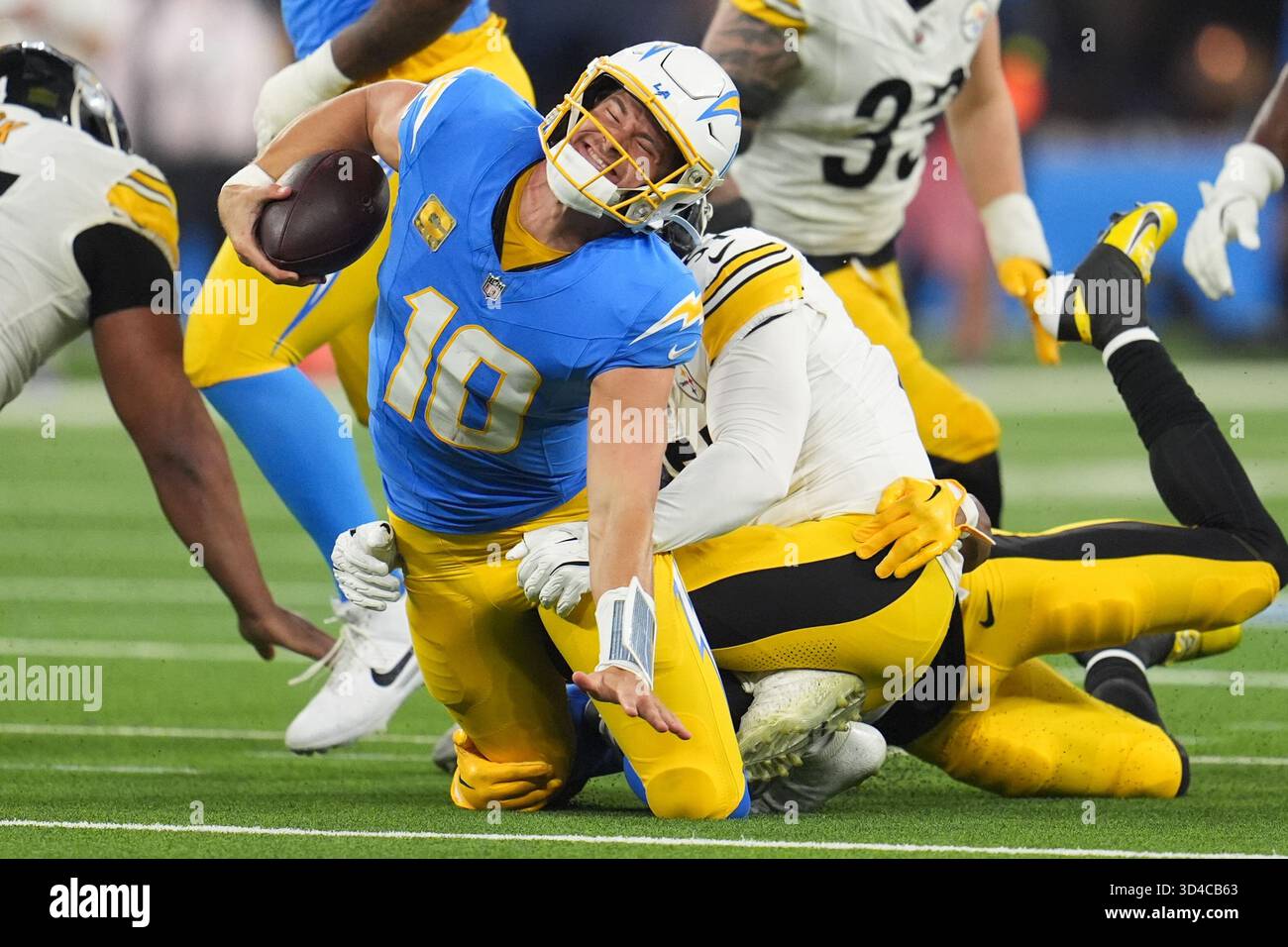 Los Angeles Chargers quarterback Justin Herbert (10) grimaces as he is ...
