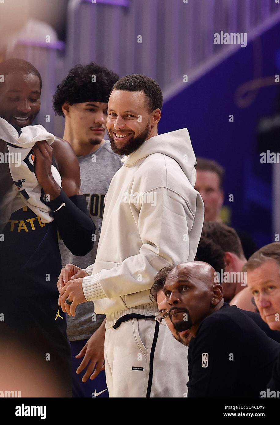 Golden State Warriors guard Stephen Curry, center, stands at the bench ...