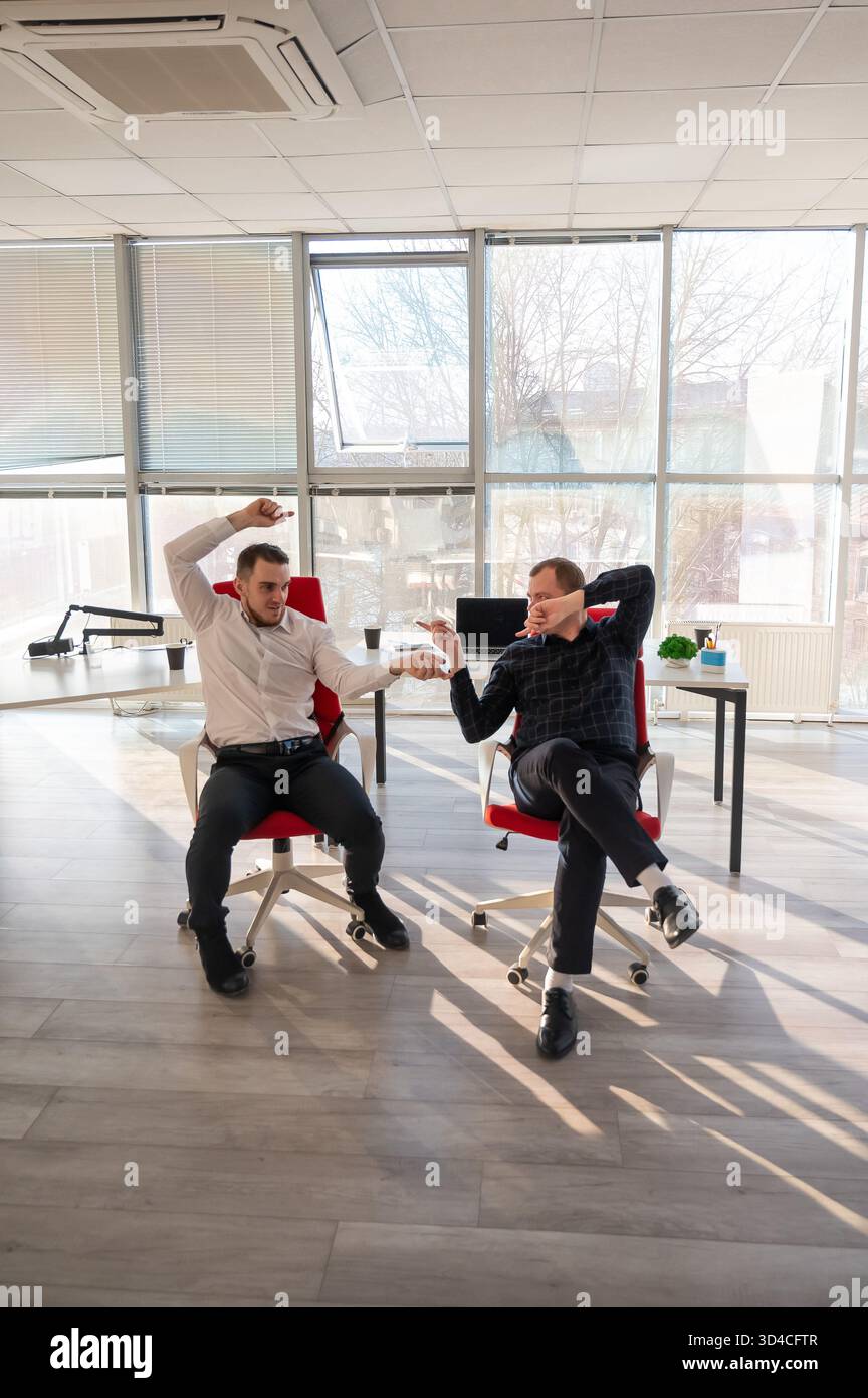 Two Caucasian men having fun at work Stock Photo - Alamy