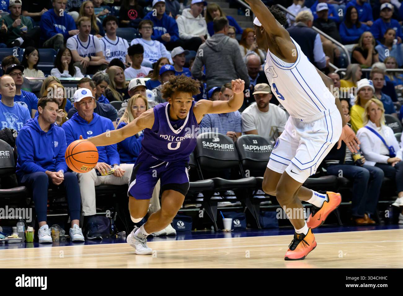 Holy Cross guard Tyler Boston (0) drives to the basket guarded by BYU ...