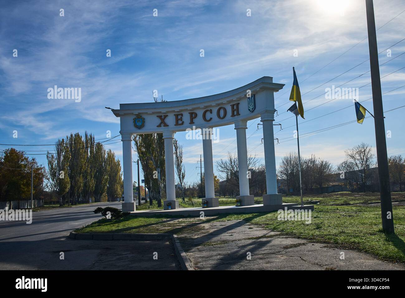A sign reading "Kherson" by the national flag is seen on the deserted ...
