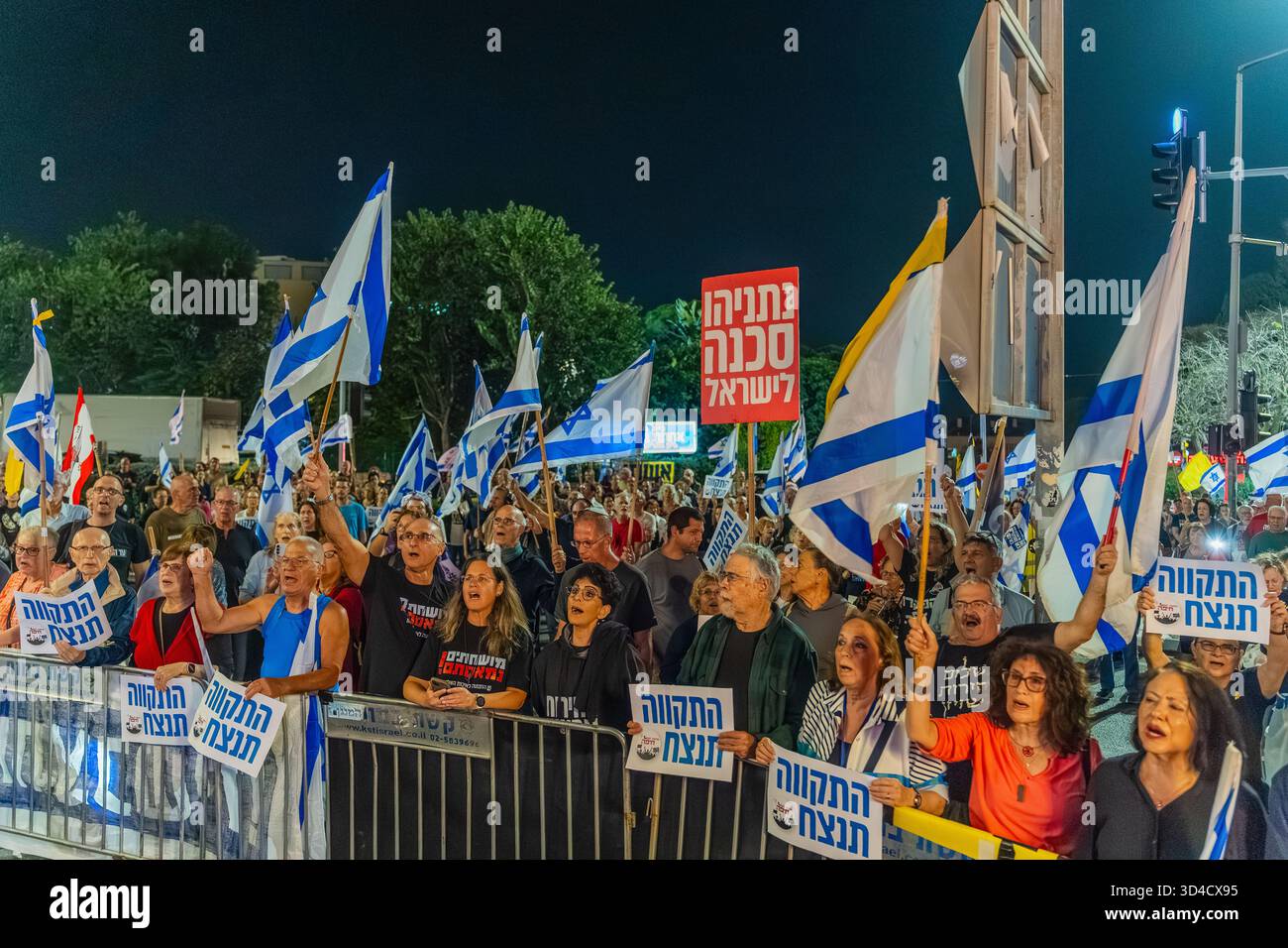Haifa, Israel - November 08, 2025: Crowd of people raise signs - the ...