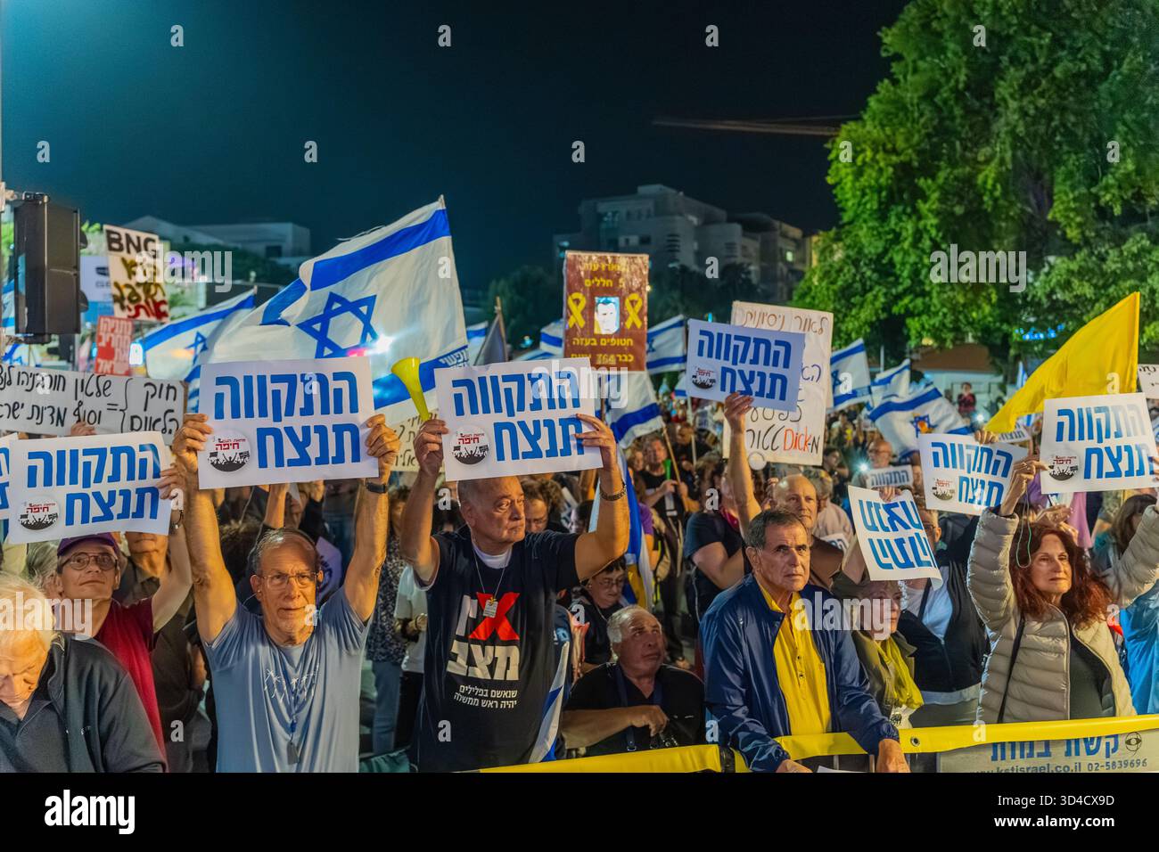 Haifa, Israel - November 08, 2025: Crowd of people raise signs - the ...