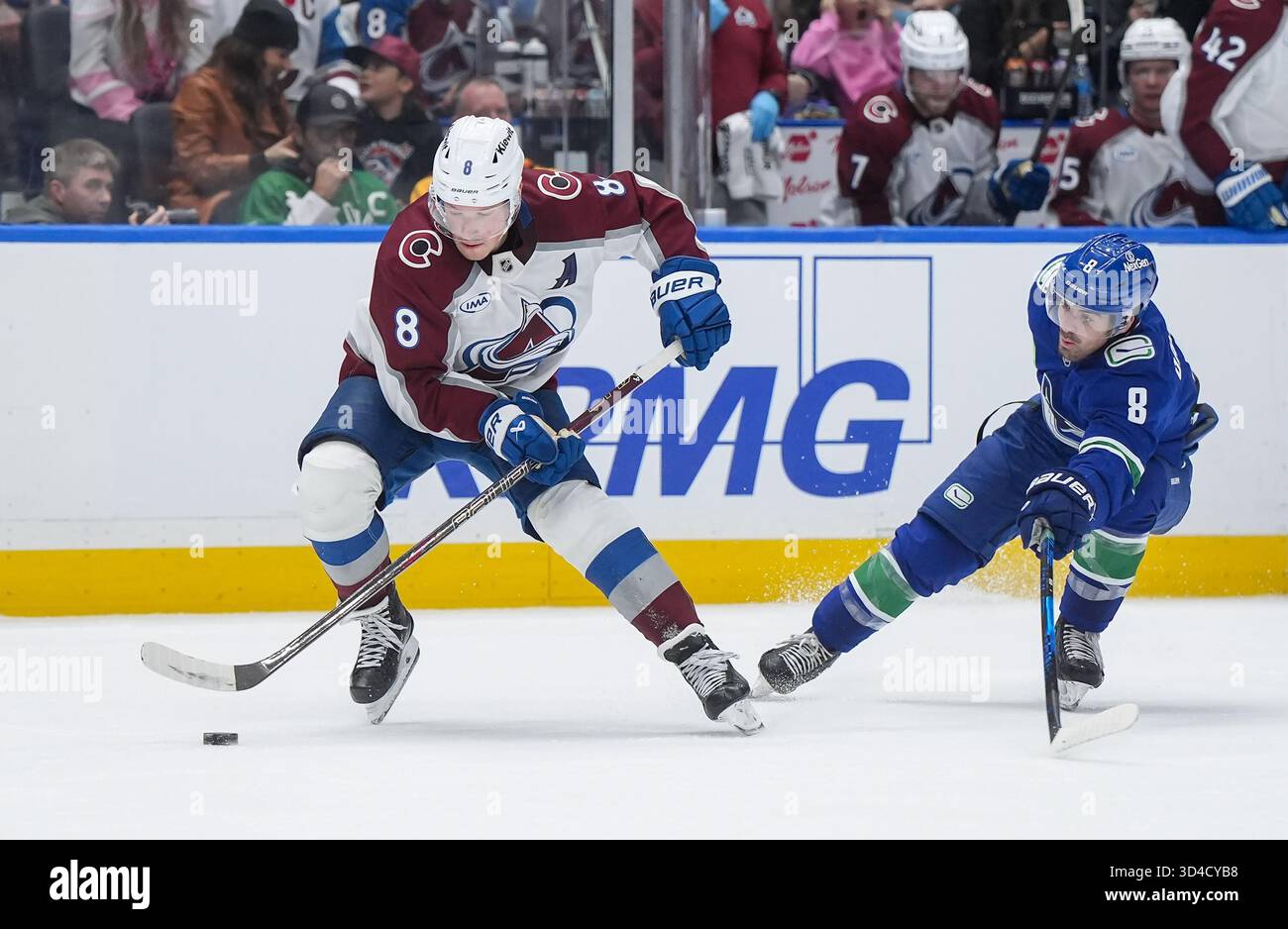 Colorado Avalanche's Cale Makar, left, turns away from Vancouver ...