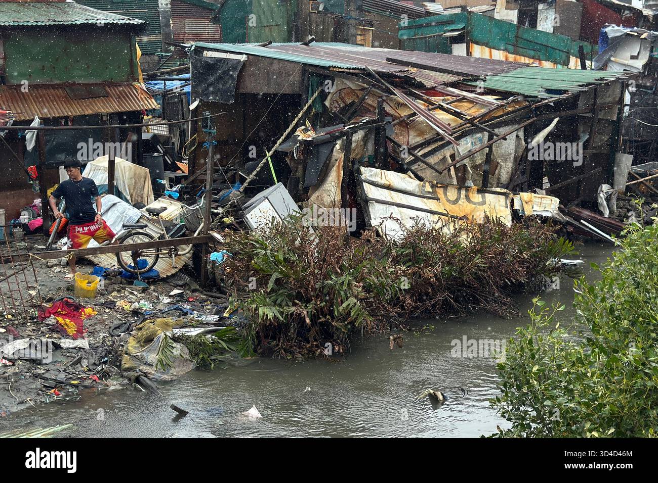 A man checks a damaged house due to Typhoon Fung-wong along a coastal ...